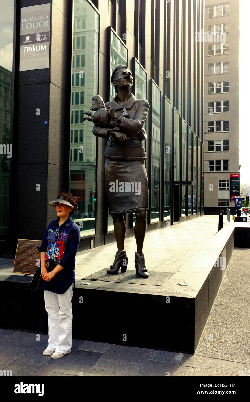 A woman poses by a statue in Old montreal Stock Photo - Alamy