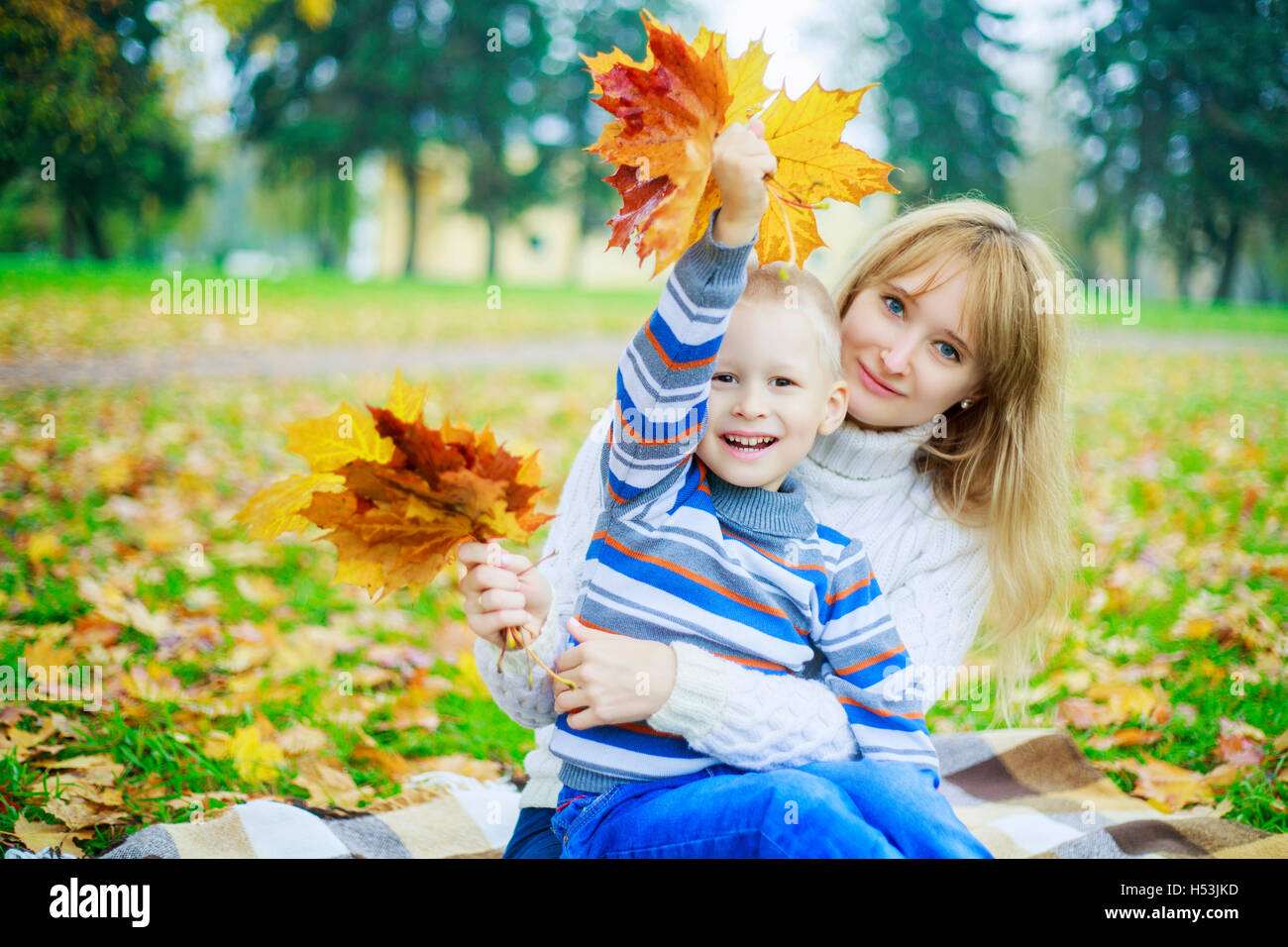 happy young mother and son in the autumn park Stock Photo - Alamy
