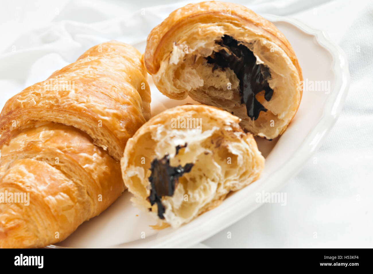 croissant with chocolate is broken close up Stock Photo - Alamy