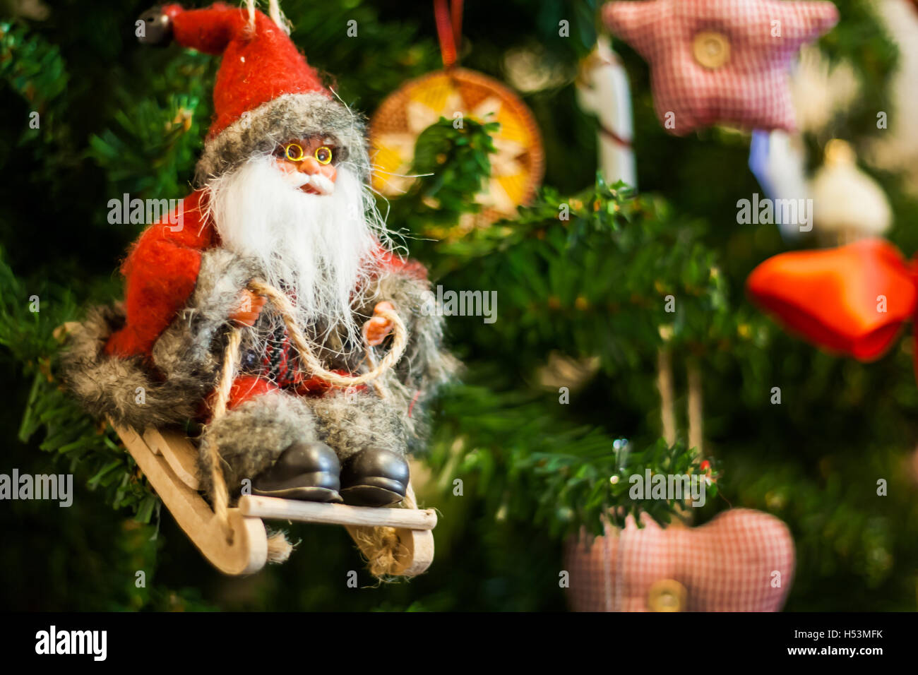 Santa Claus on a sledge toy on Christmas tree Stock Photo - Alamy