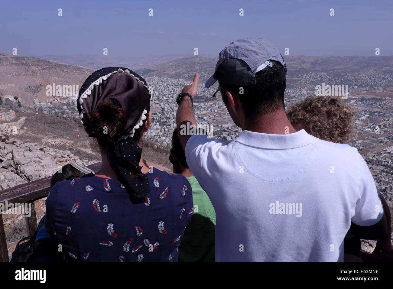 A Jewish settler family gazing from an observation point on Mount ...