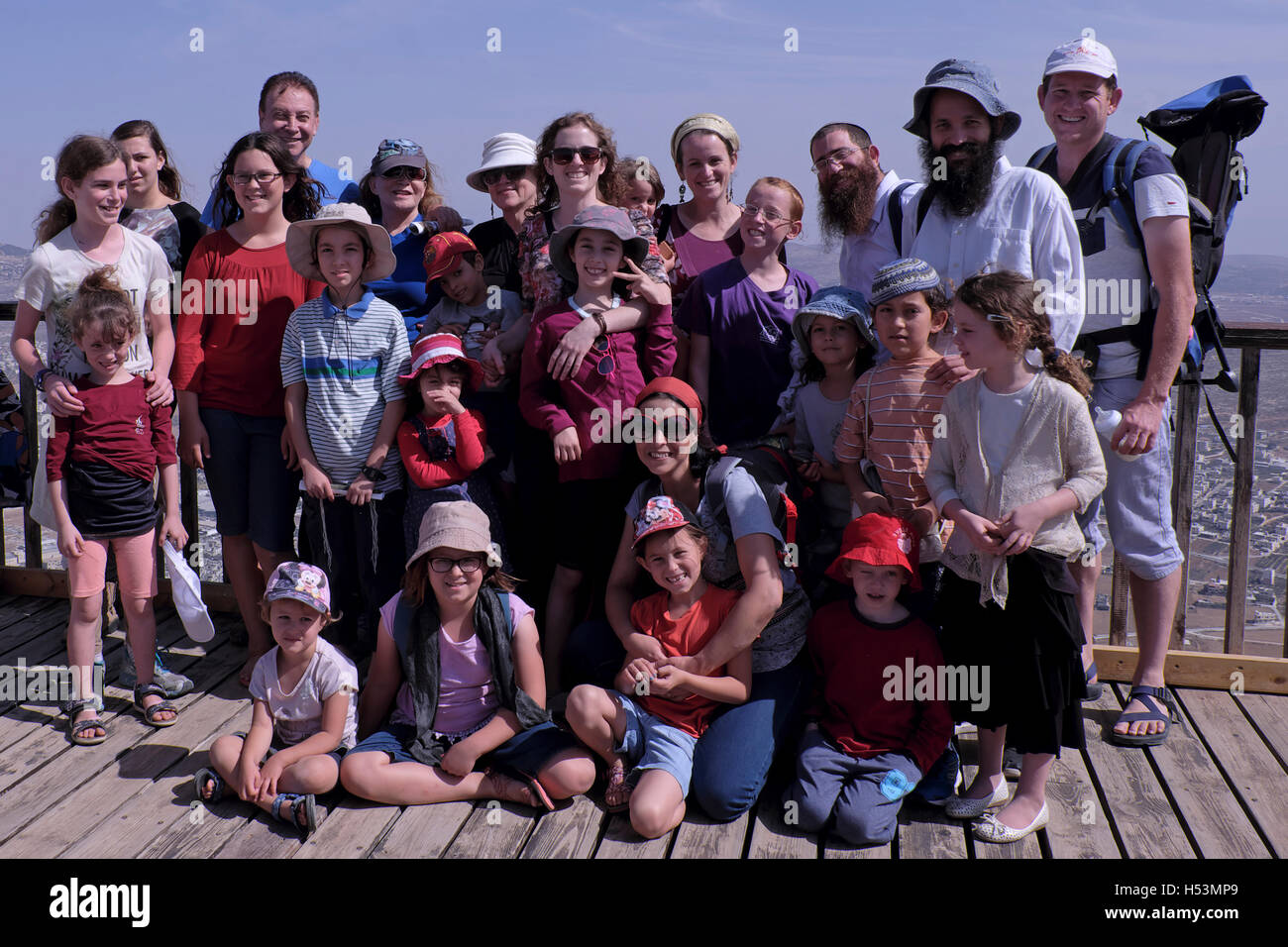 A religious Jewish family posing to the camera in an observation point ...