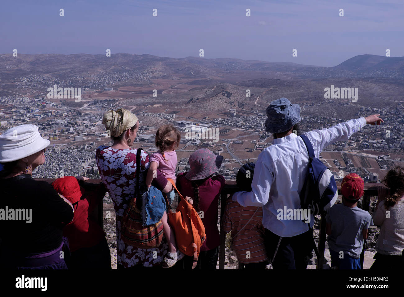A Jewish settler family gazing from an observation point on Mount ...