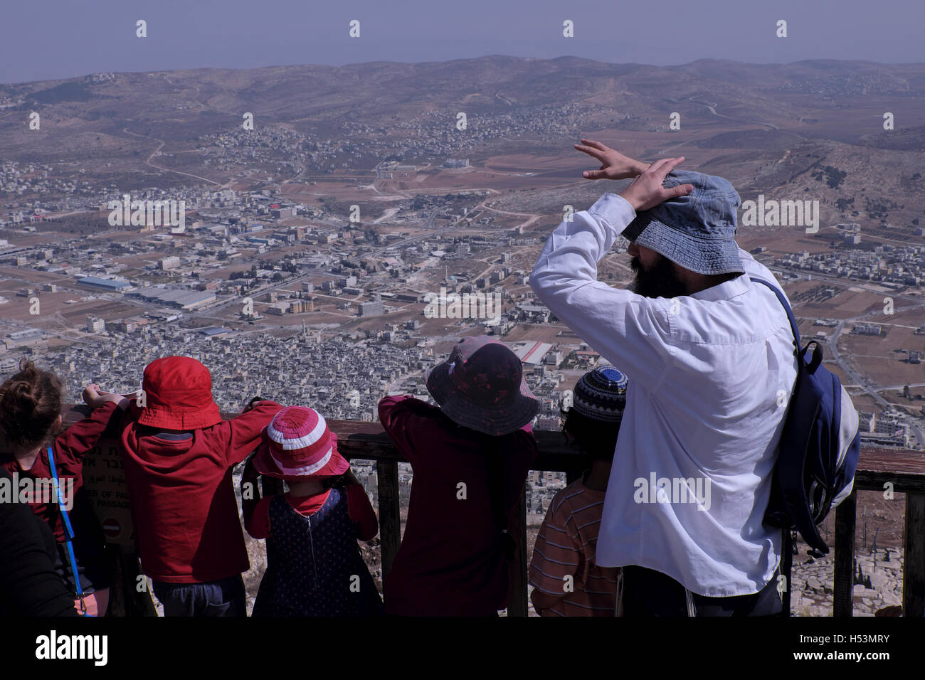 A Jewish settler family gazing from an observation point on Mount ...