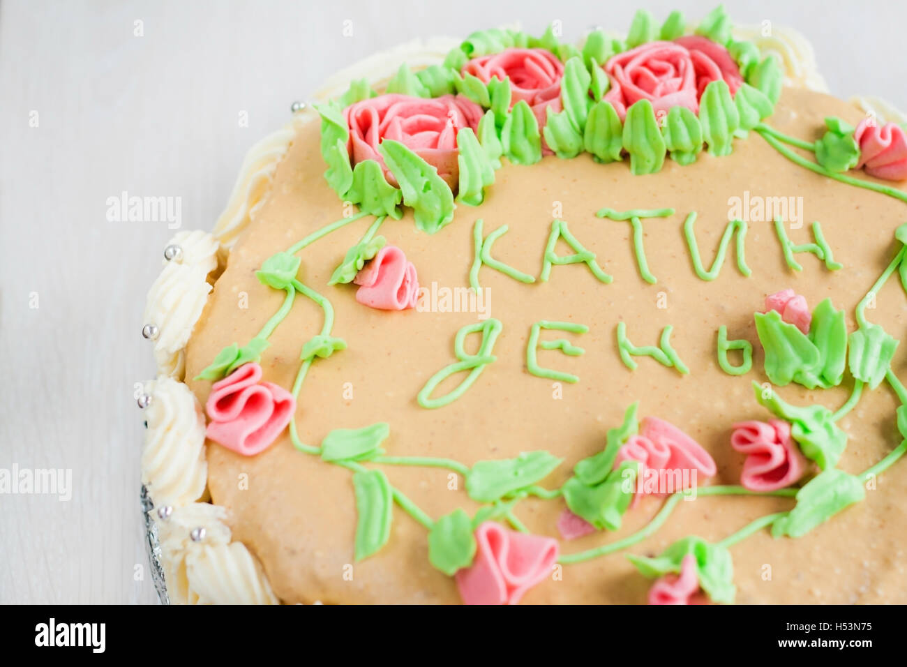 birthday cake decorated with roses, leaves, swirls and the inscription ...