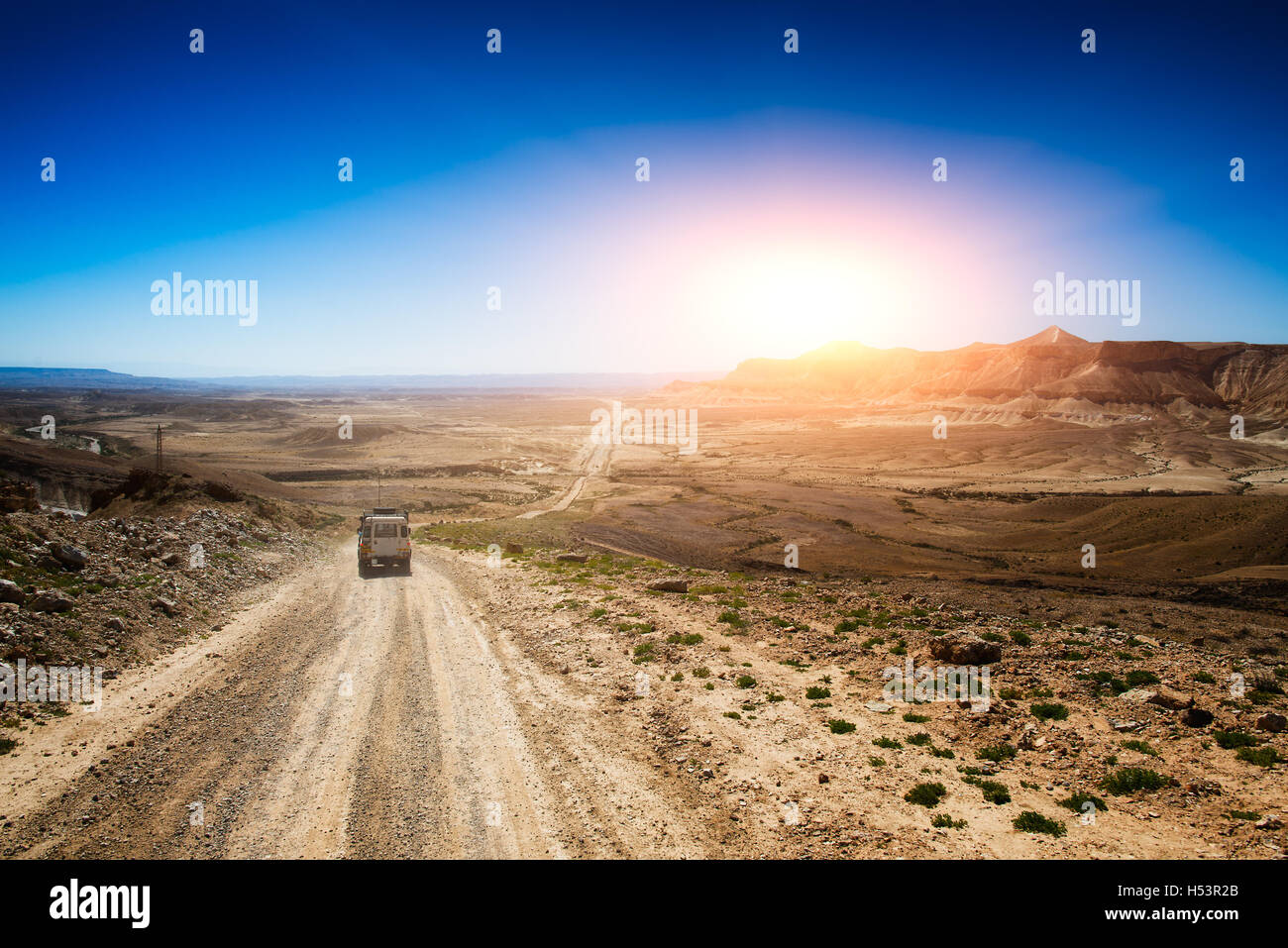 Jeep in a desert road Stock Photo - Alamy