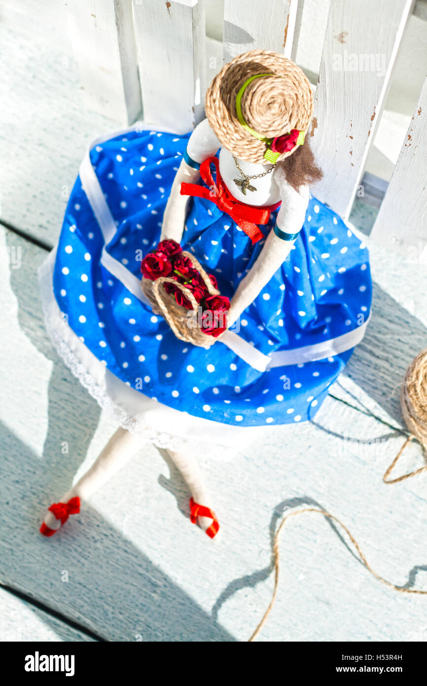 tilde doll in a blue skirt and a straw hat with a basket with flowers ...