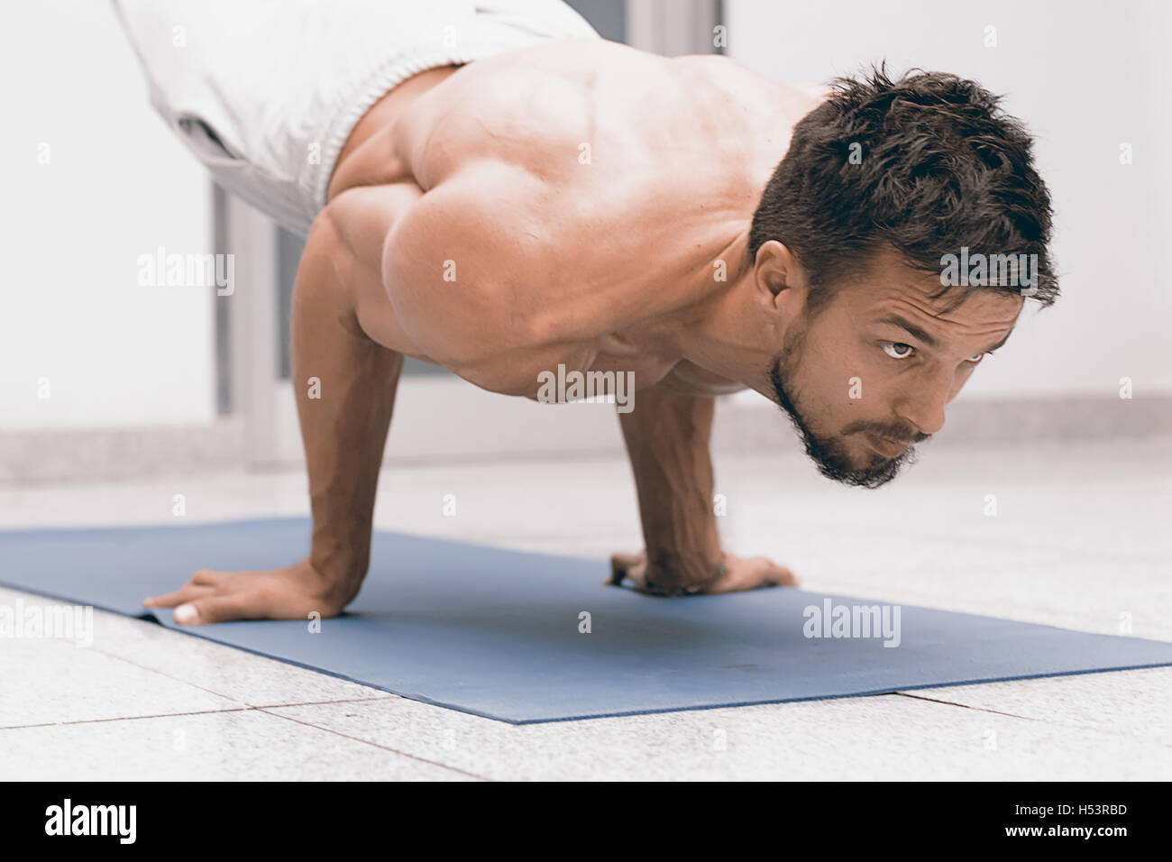 Handsome athlete working extreme push ups Stock Photo - Alamy