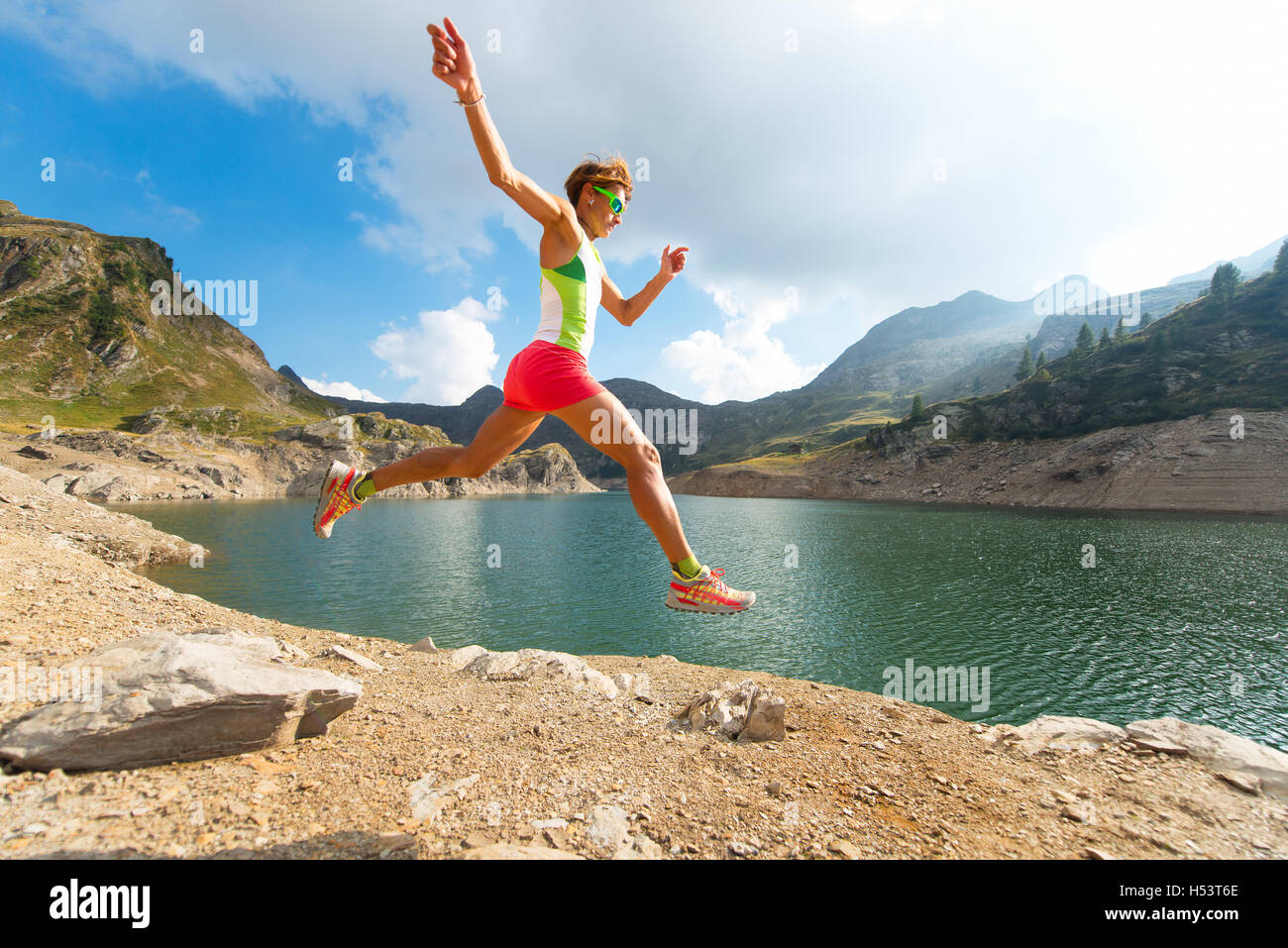 Jump during skyrunning Girl in training Stock Photo - Alamy