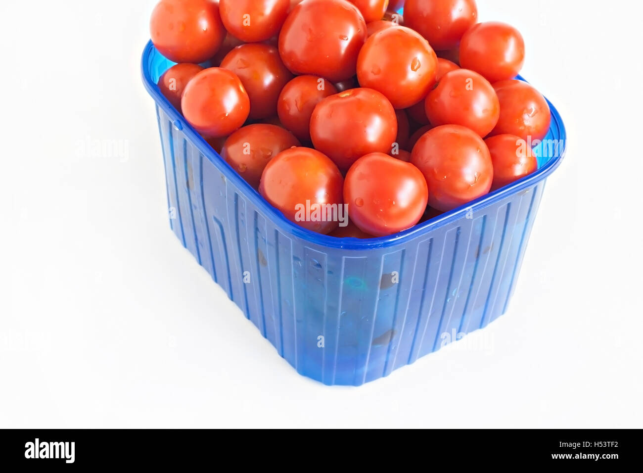 blue plastic box full of tomatoes isolated Stock Photo - Alamy