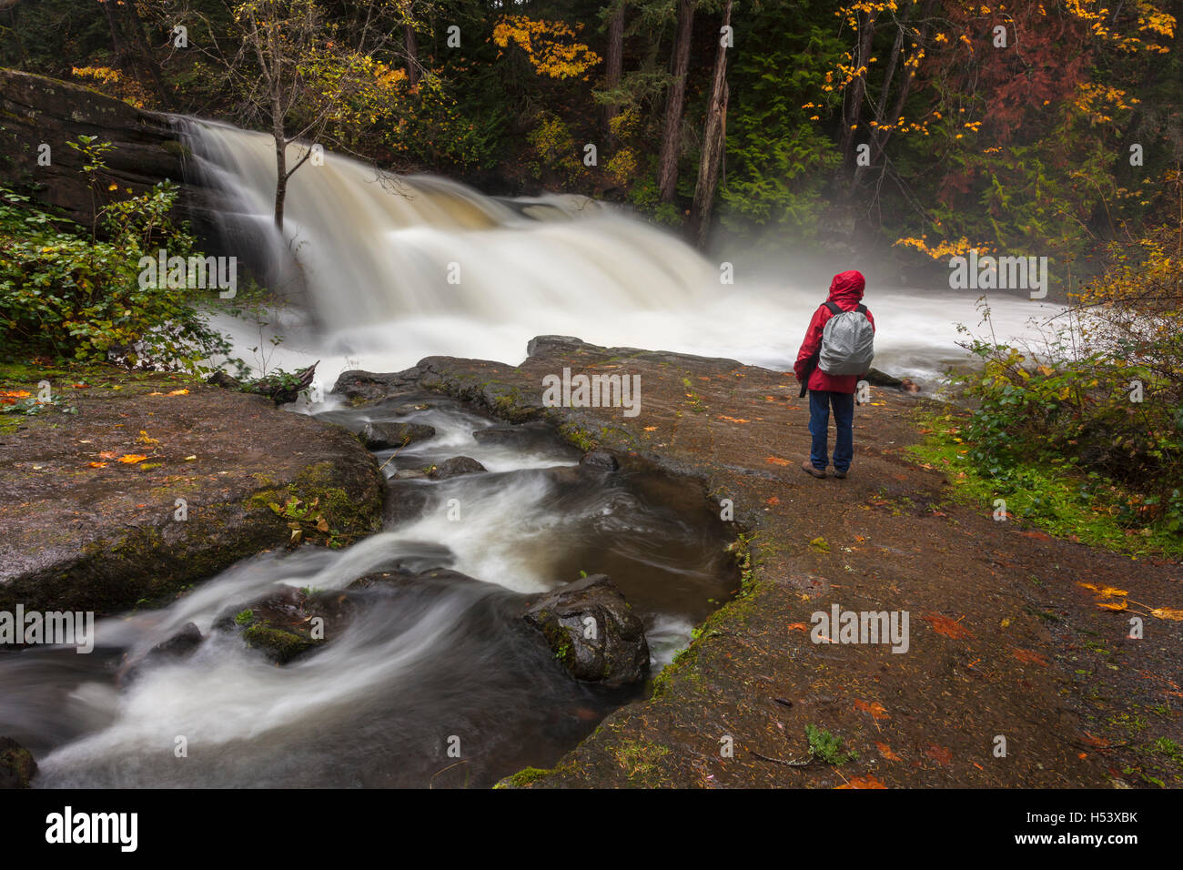 Photographer watching fast flowing Millstone River and waterfall on ...