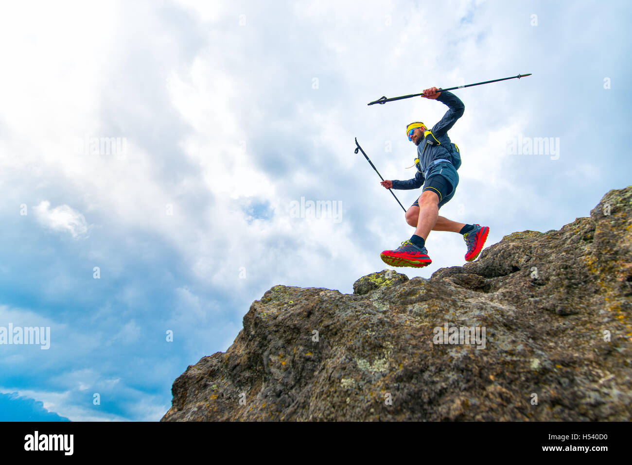 Male athlete falls over a cliff with sticks while practical training at ...