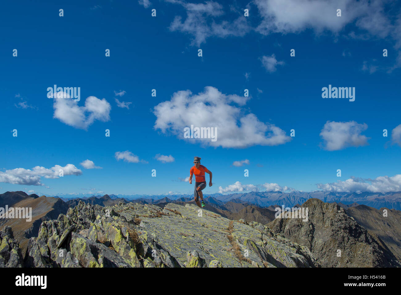 Man practice skyrunning in high mountain alone Stock Photo - Alamy