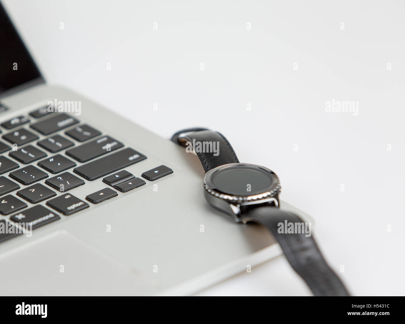 smartwatch on top of a laptop. smartwatch on standby, focus on keyboard ...