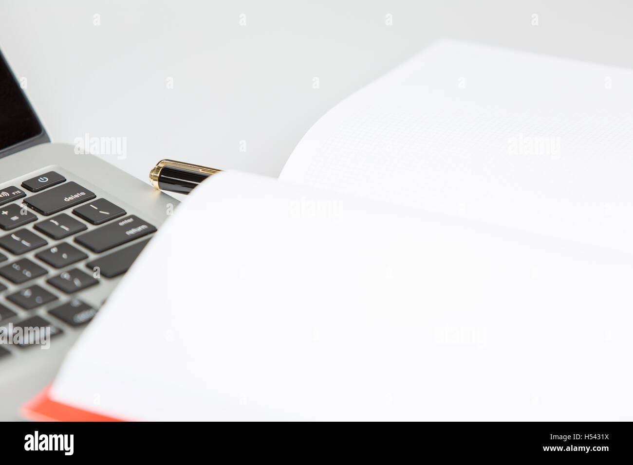 Open book in top of laptop hi-res stock photography and images - Alamy