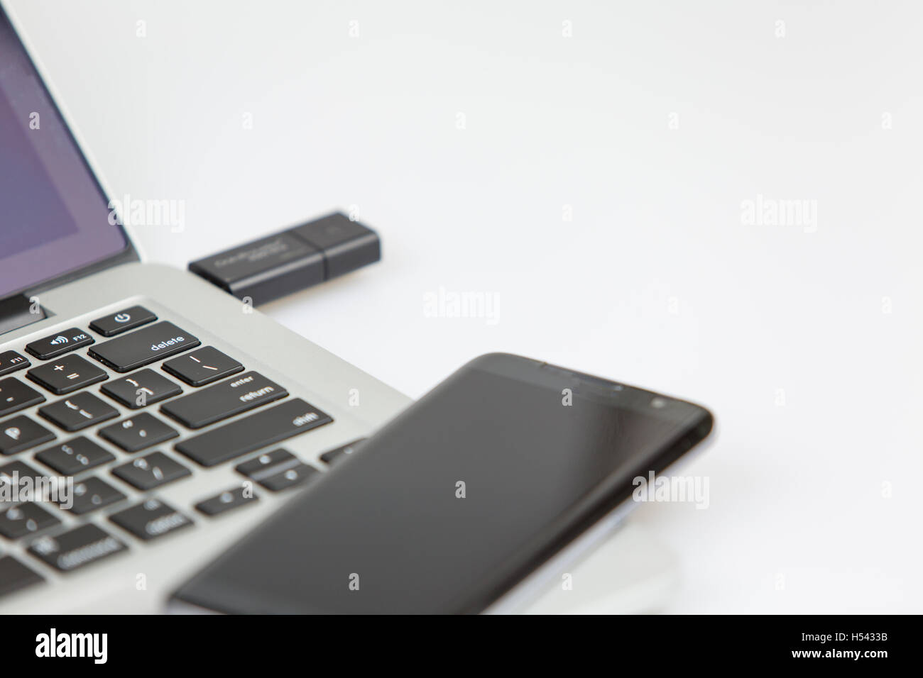 a black usb stick plugged on the right side of laptop. closeup shot ...