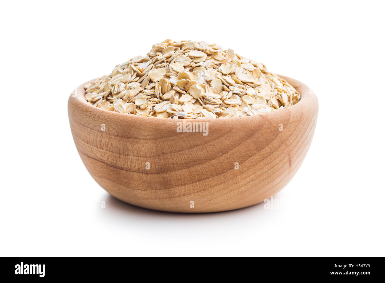 Dry rolled oatmeal in wooden bowl isolated on white background Stock ...
