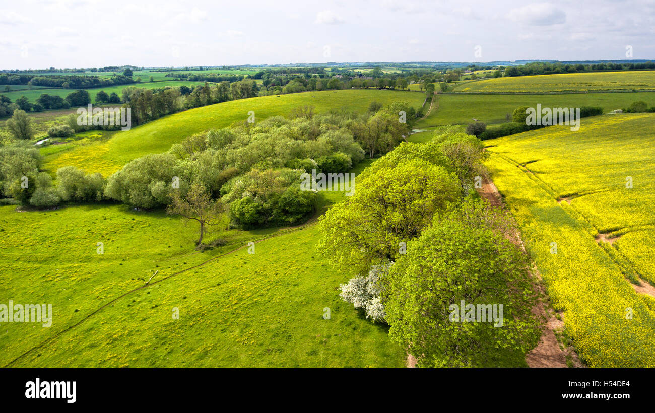 Springtime aerial view of hilly fields, meadows patterned with country ...