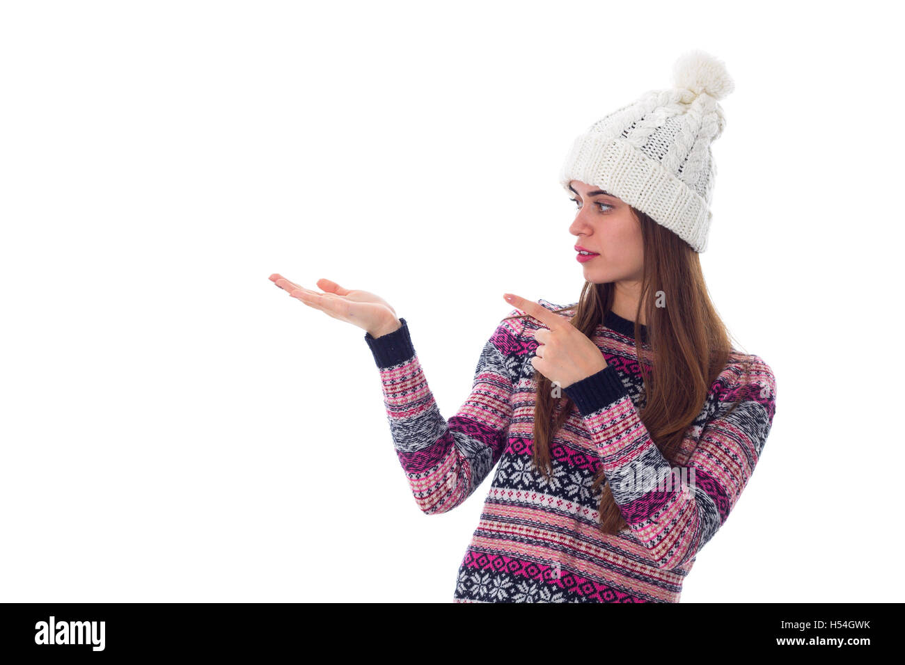 Woman in sweater and white hat holding something Stock Photo - Alamy