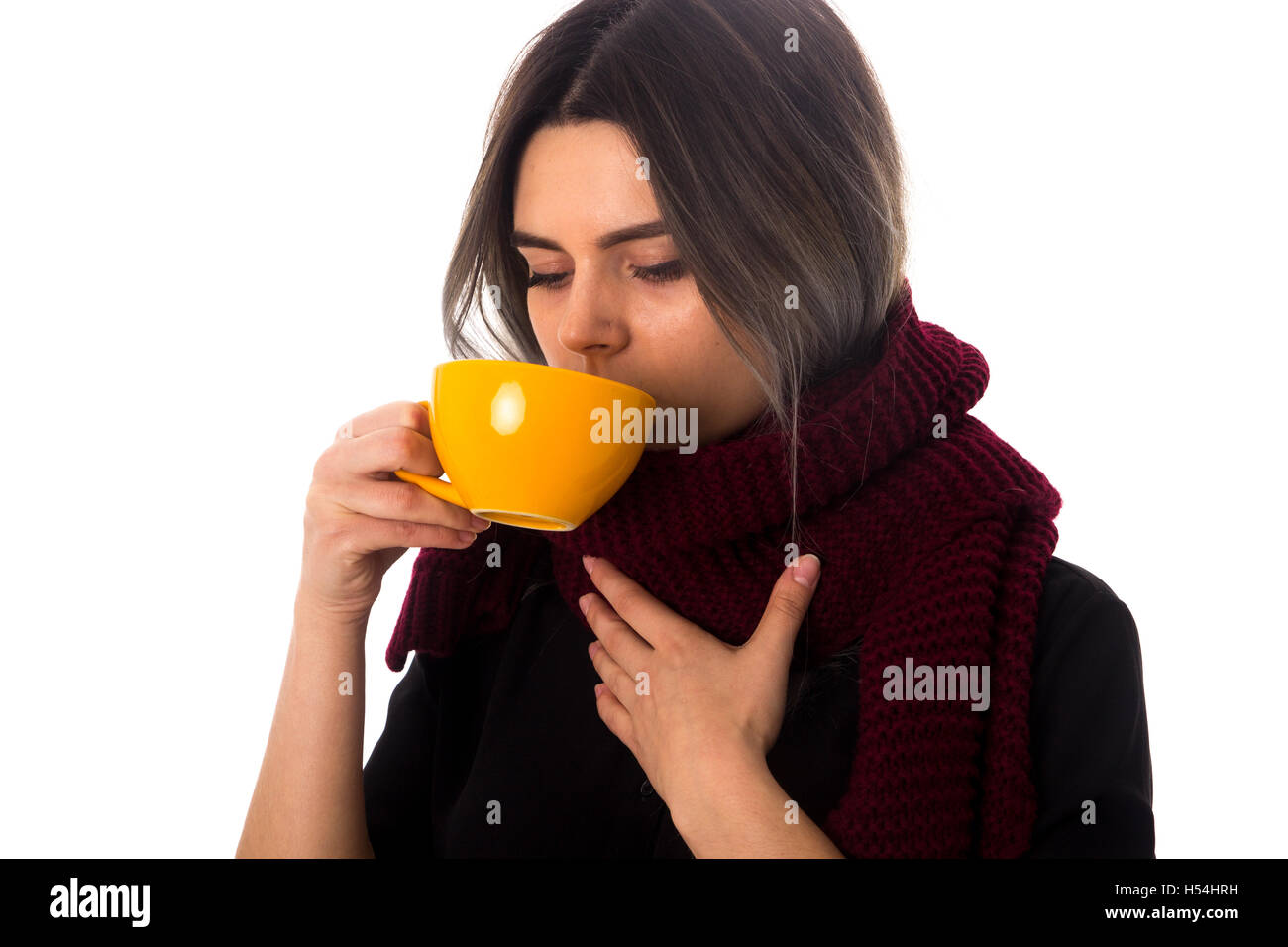 Woman drinking from yellow cup Stock Photo - Alamy