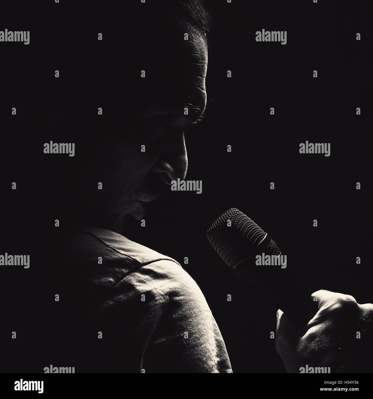 Act of a man with microphone, angry facial expression Stock Photo - Alamy