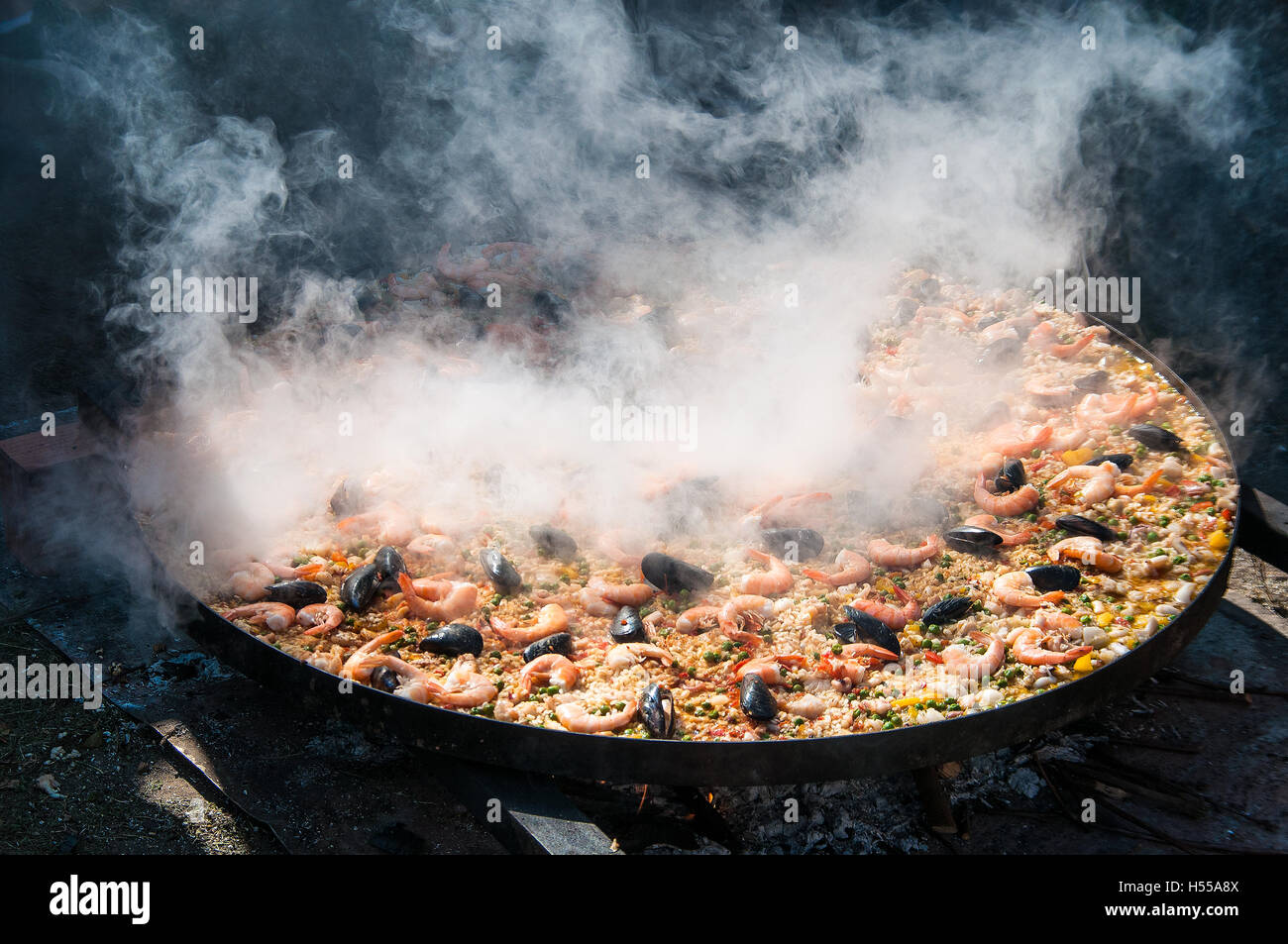 Cooking paella in large pot Stock Photo - Alamy
