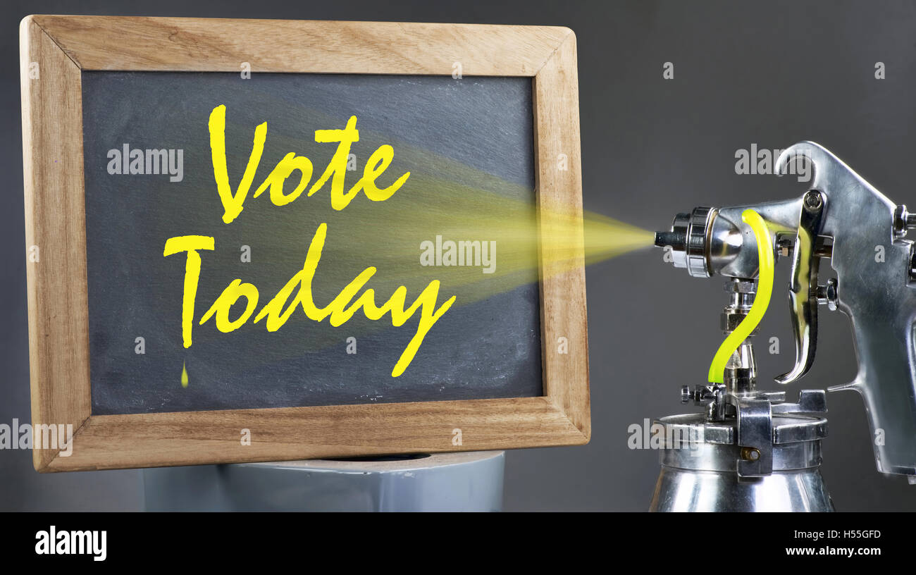 Spray painting vote today on blackboard Stock Photo - Alamy