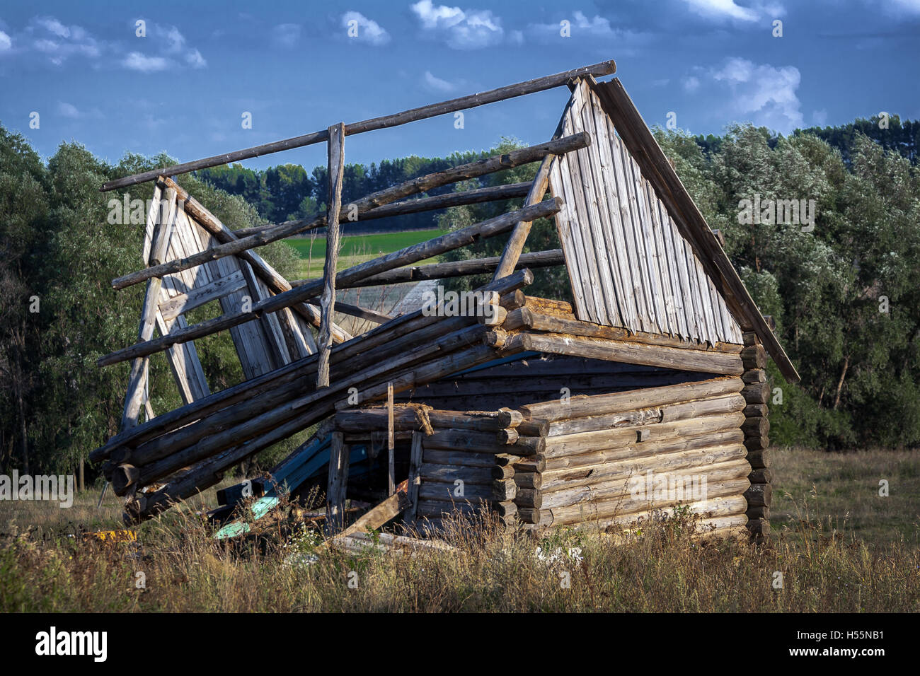the destroyed wooden house in the wood Stock Photo - Alamy