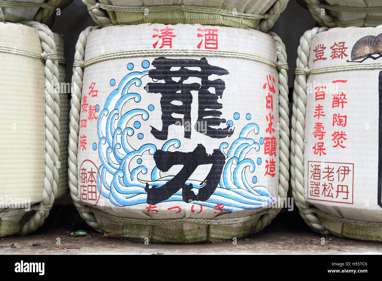 Detail of a traditional japanese sake cask surrounded by other casks in ...