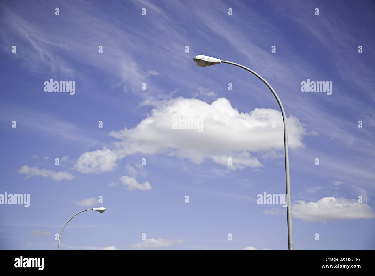 Streetlights in the sky, detail of lampposts in the city, with clouds ...