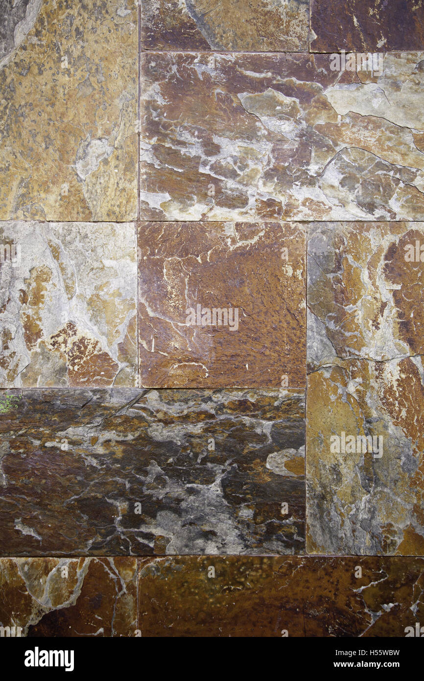 Rusty stone wall, detail of a wall of stone tiles, textured background ...