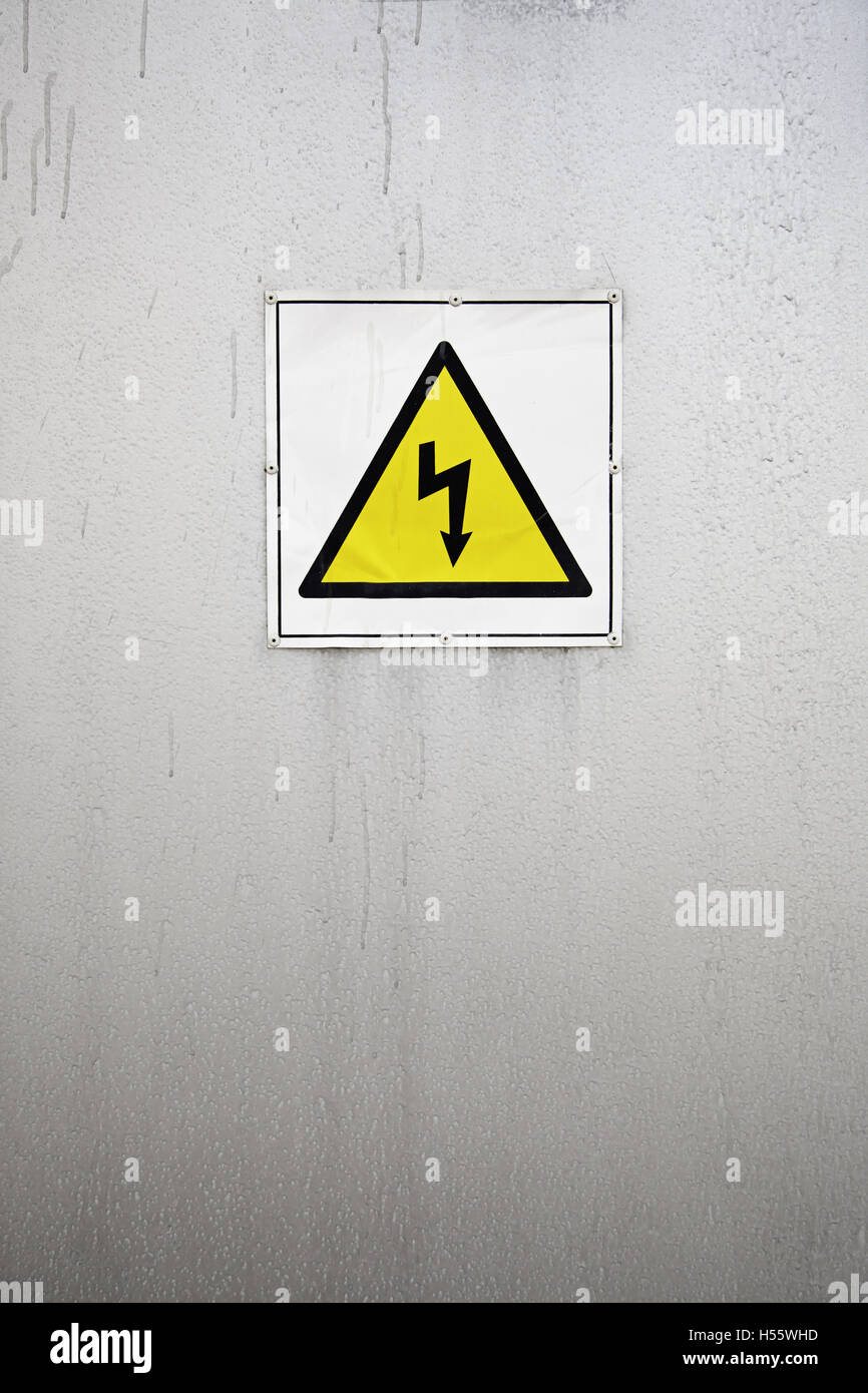 Electrical warning sign, detail of a caution sign on a metal wall ...