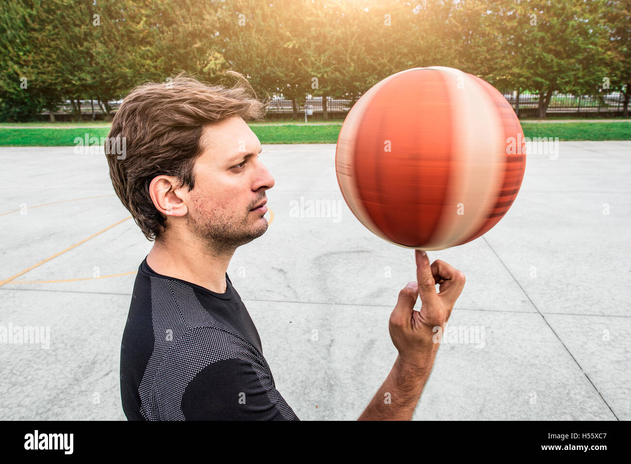 Performance of a white basketball player on the outdoor field in the ...