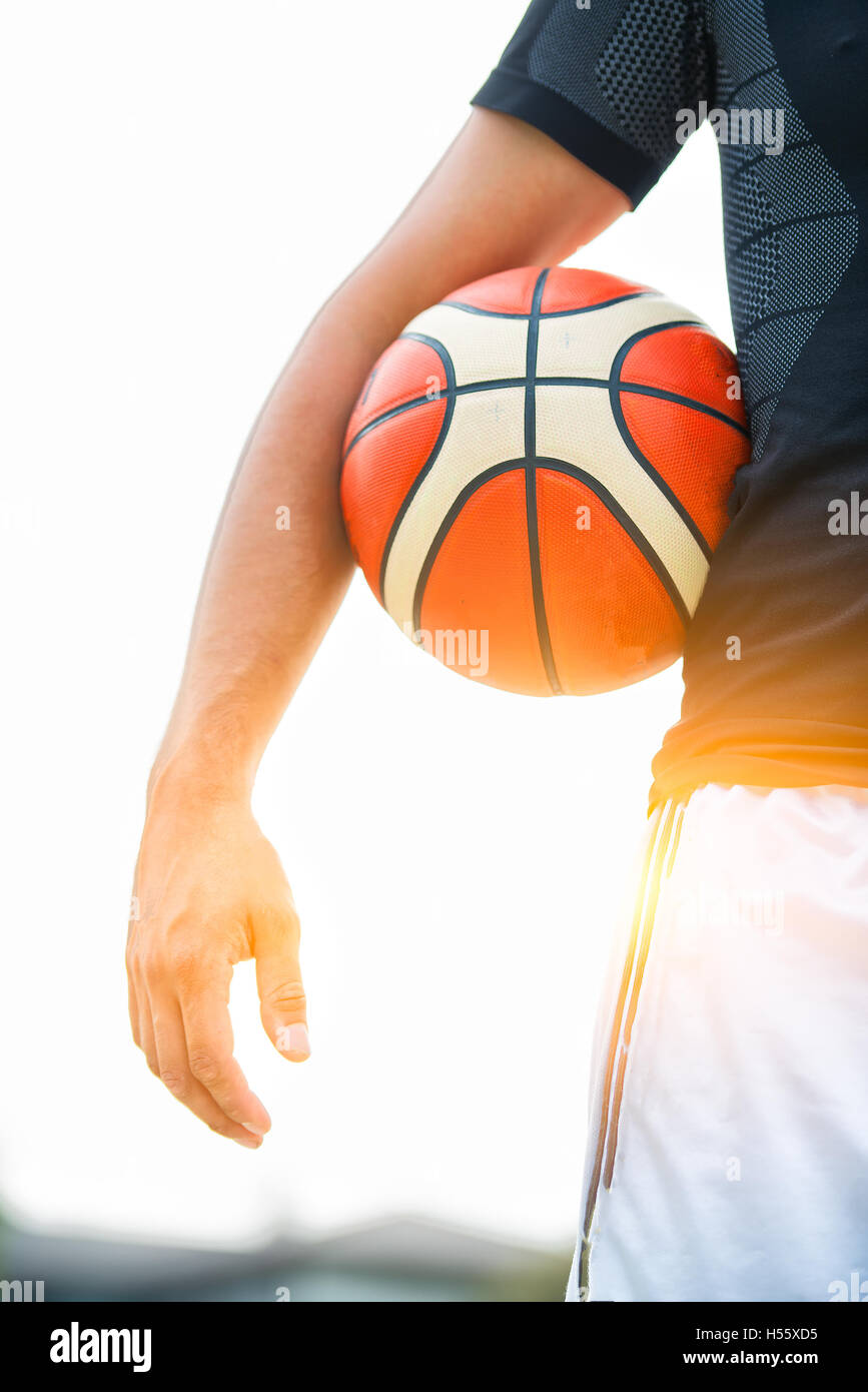 Performance of a white basketball player on the outdoor field in the ...