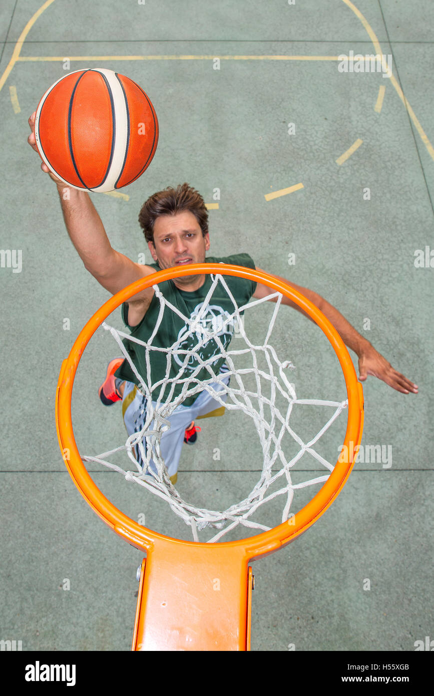 Performance of a white basketball player on the outdoor field in the ...