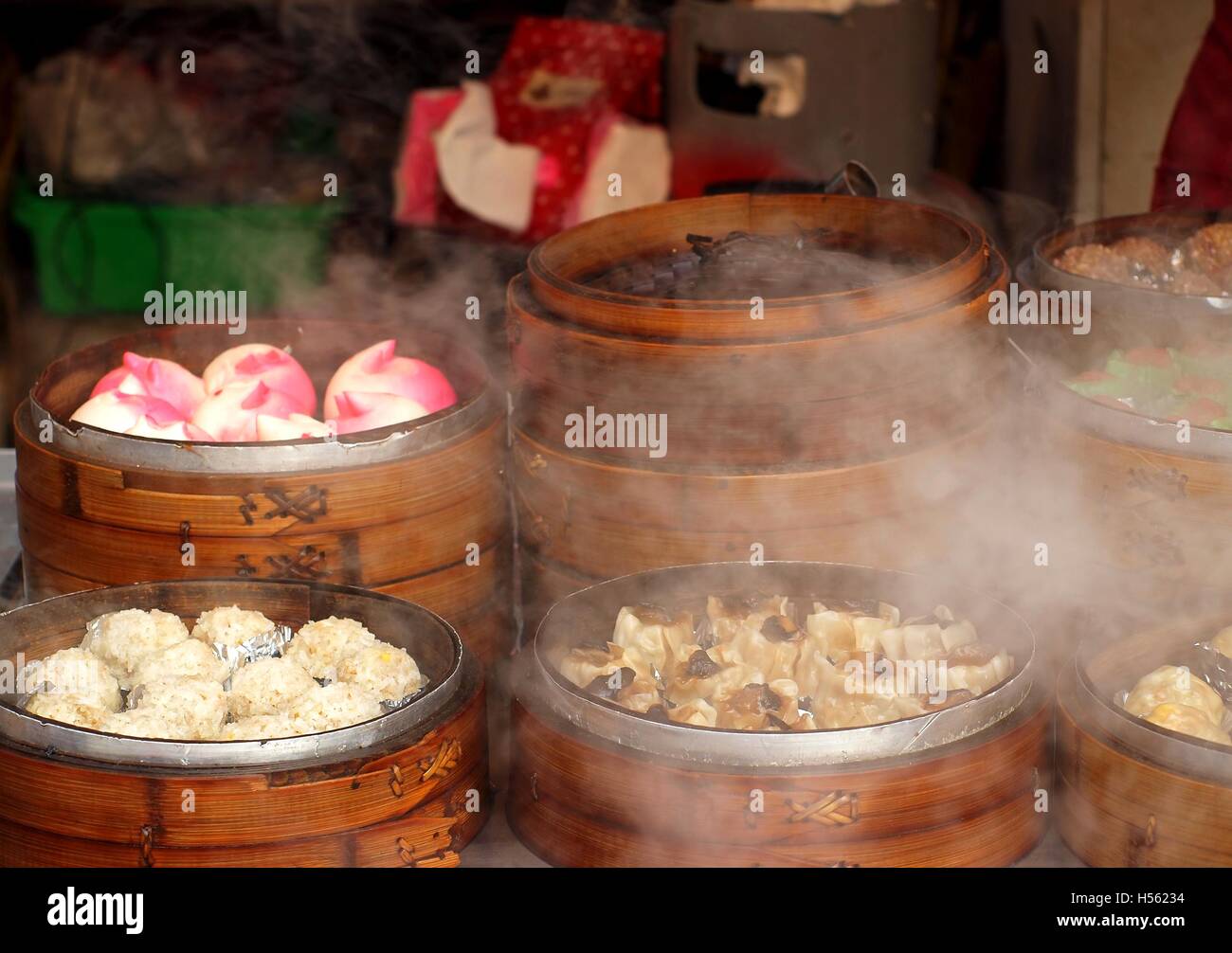 An outdoor vendor sells Cantonese Dim Sum dishes cooked in traditional ...