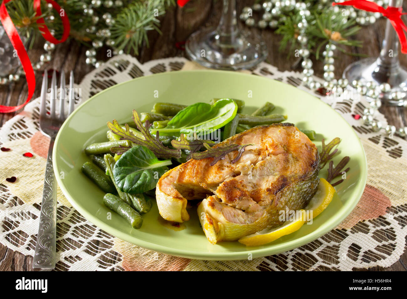 Red fish steaks cooked on the grill and green beans on a festive New ...