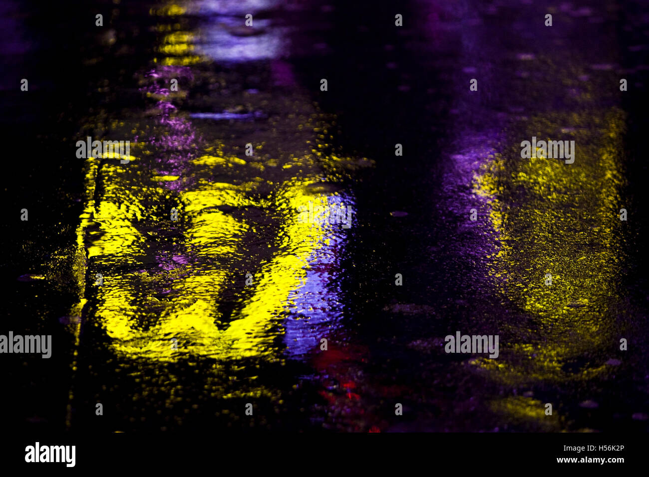 Reflection of a McDonald's neon sign on a wet surface in the rain Stock ...