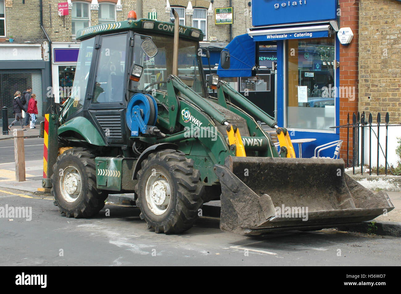 London, UK, 29/05/2016, Digger loader and steam roller road surfacing ...