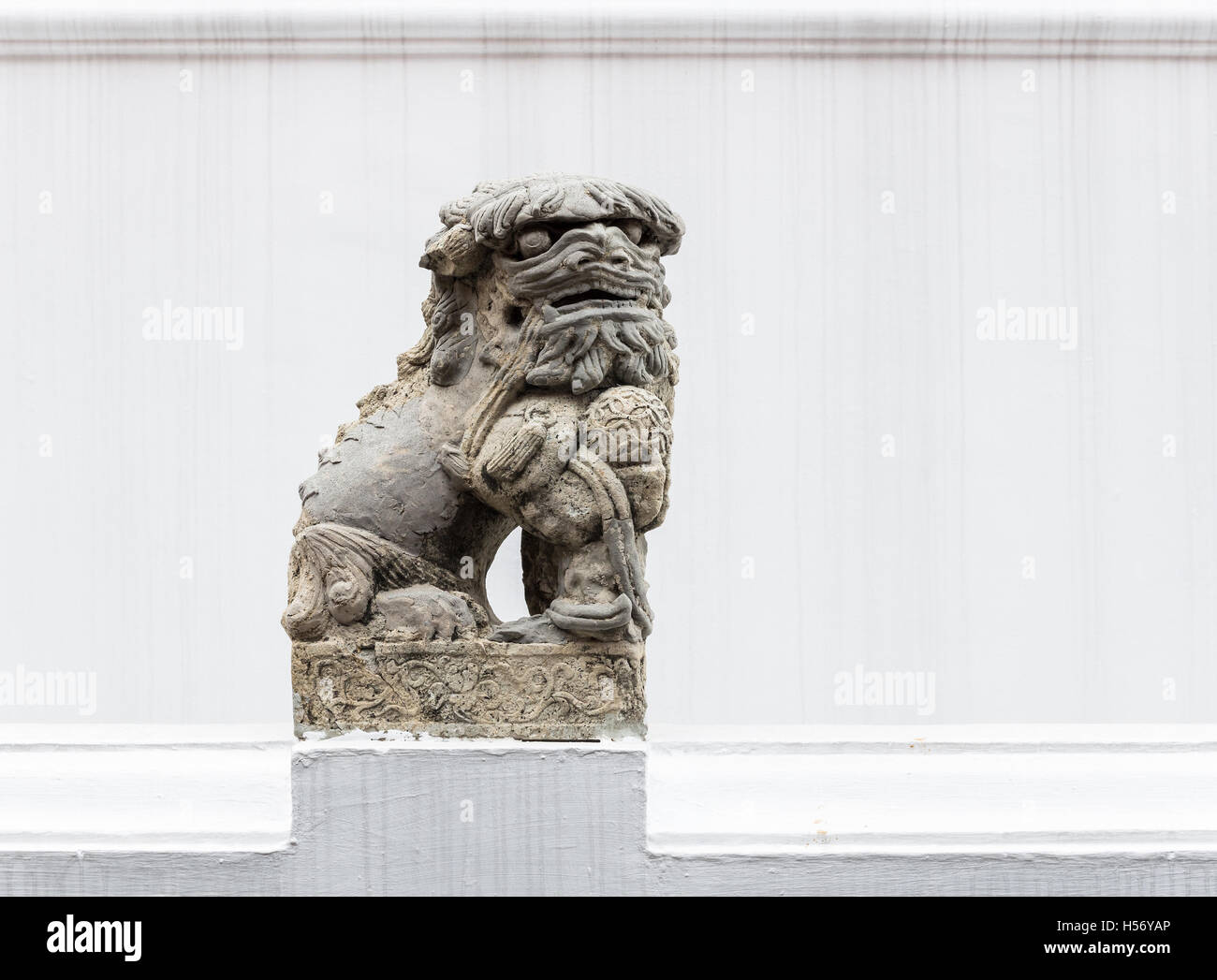 Stone lion statue in the traditional Chinese style of the Thai temple ...