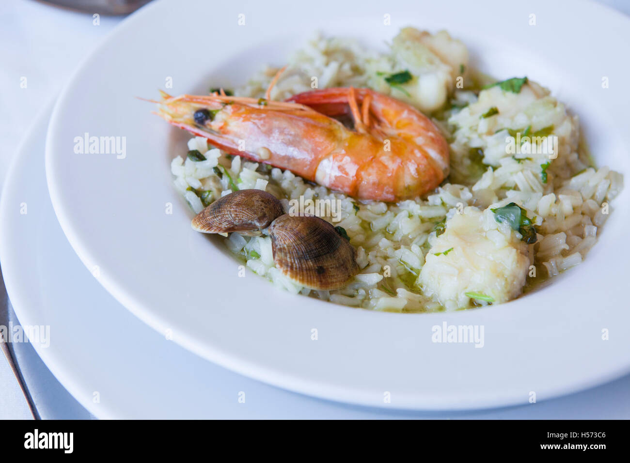 Arroz de Tamboril or soupy seafood rice on plate. Portuguese recipe ...