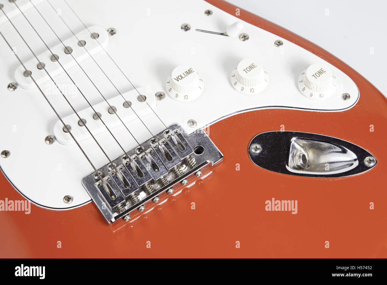 Red electric guitar, string instrument detail, rock music. detail of ...