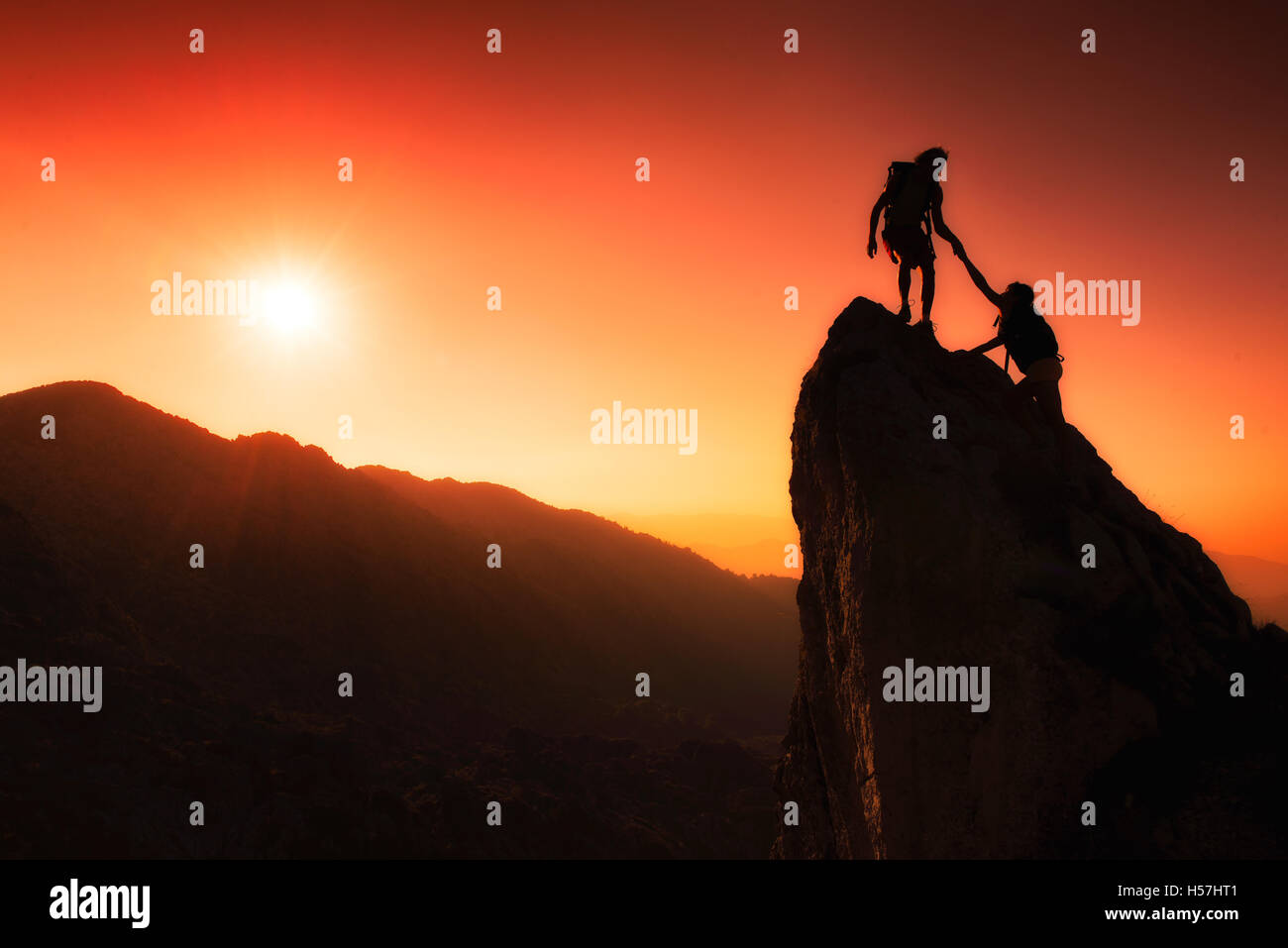 Team of climbers help to conquer the summit in teamwork in a fantastic ...