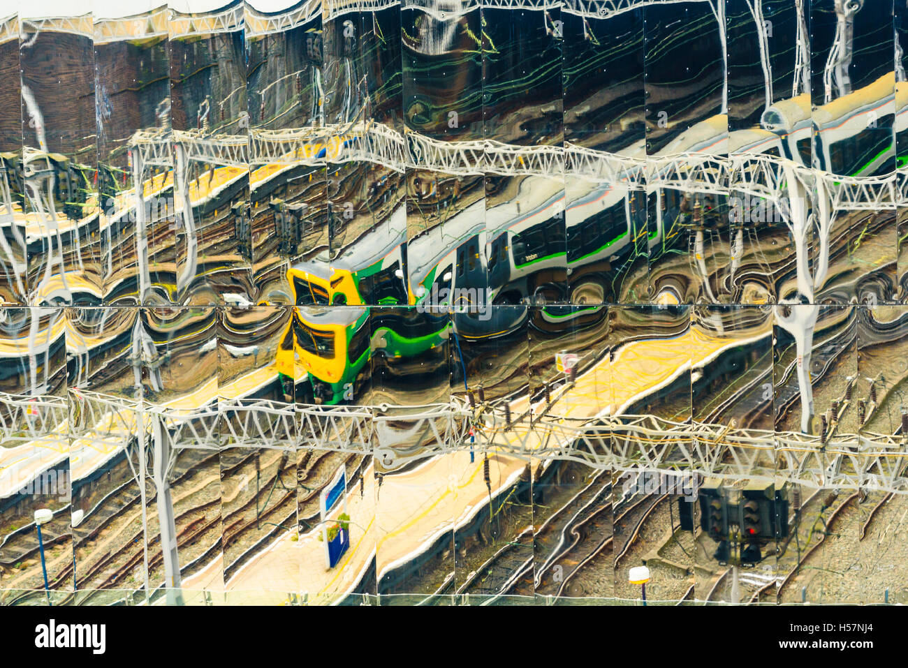 London Midland train reflected in the mirror facade of Birmingham New ...