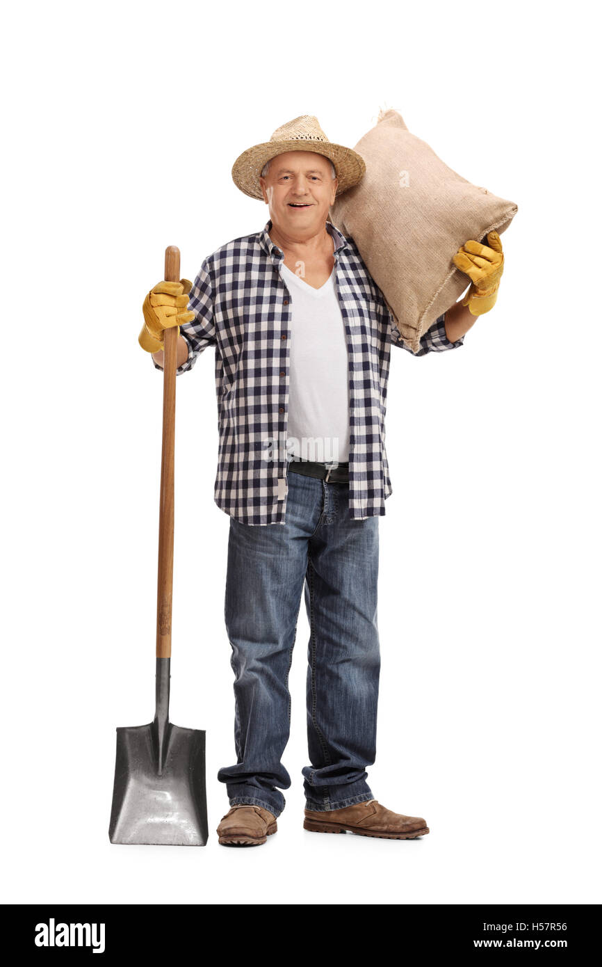 Full length portrait of a senior farmer posing with a burlap sack and a ...