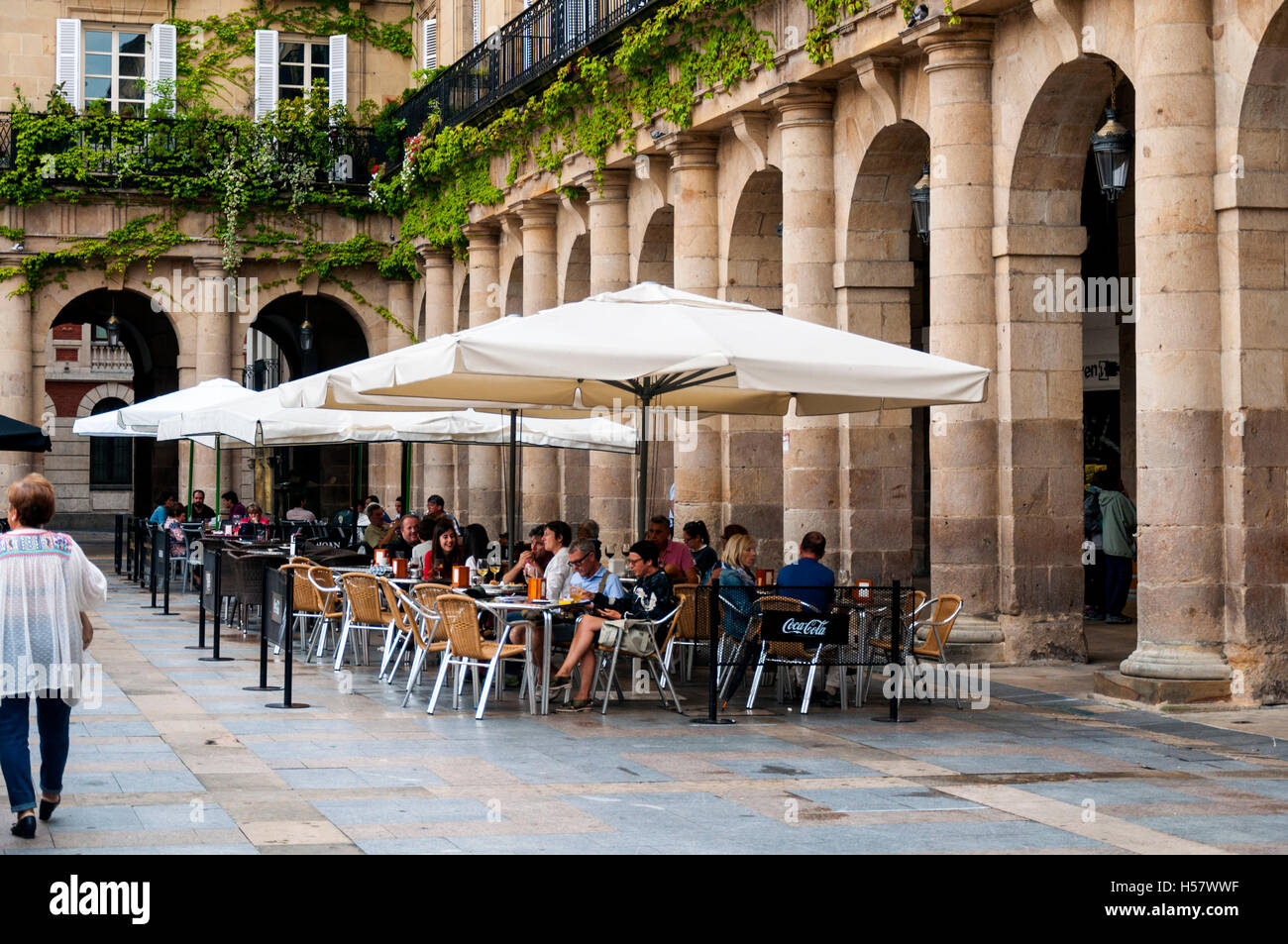 Outdoor cafe seating on Plaza Nueva, or Plaza Barria in Basque language ...