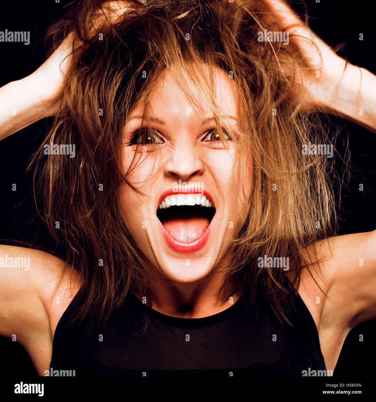 Young Silly Crazy Girl With Messed Hair Making Stupid Faces On Black Background Lifestyle