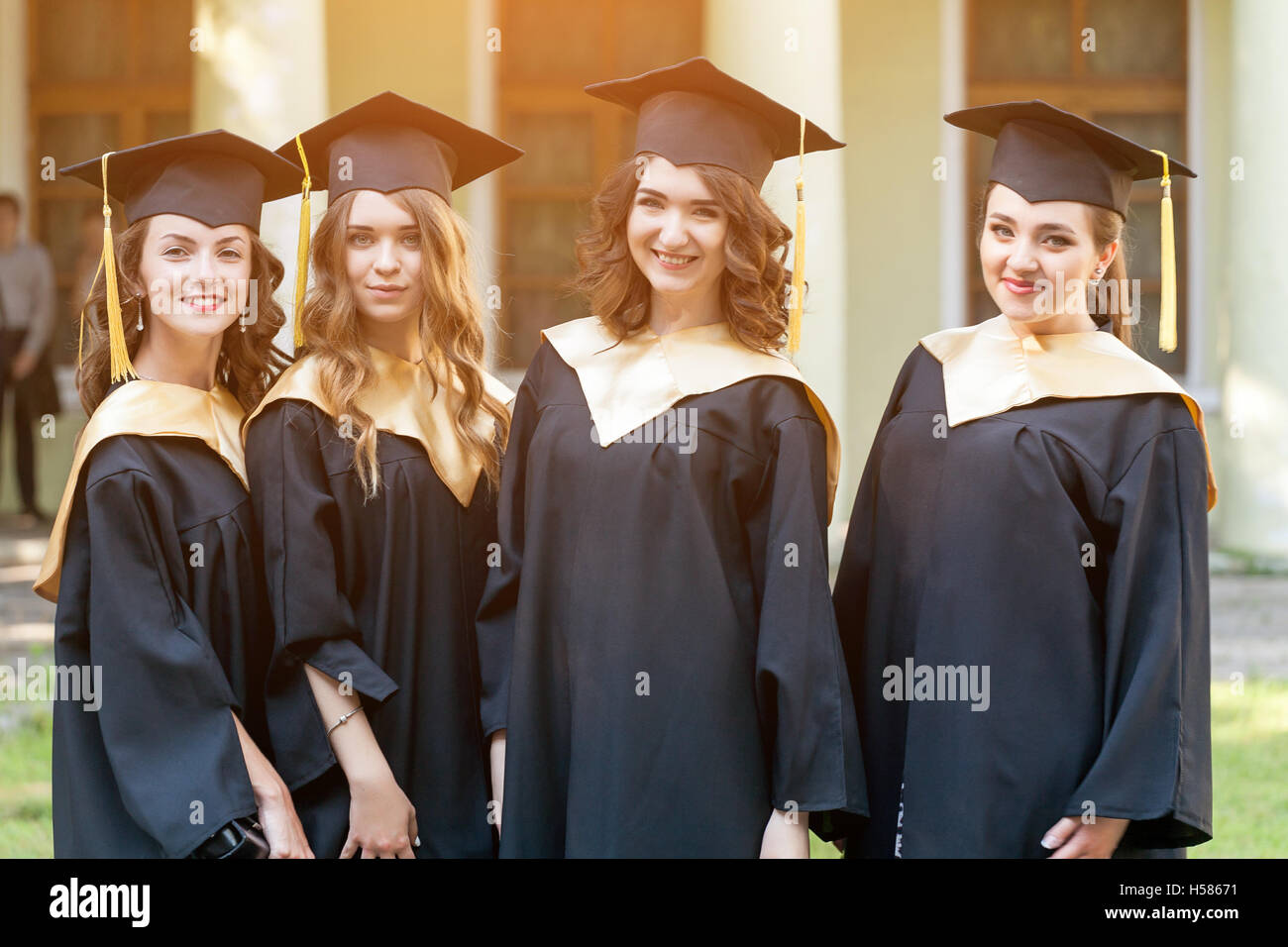 Portrait of happy students in graduation gowns. Happy graduation day ...