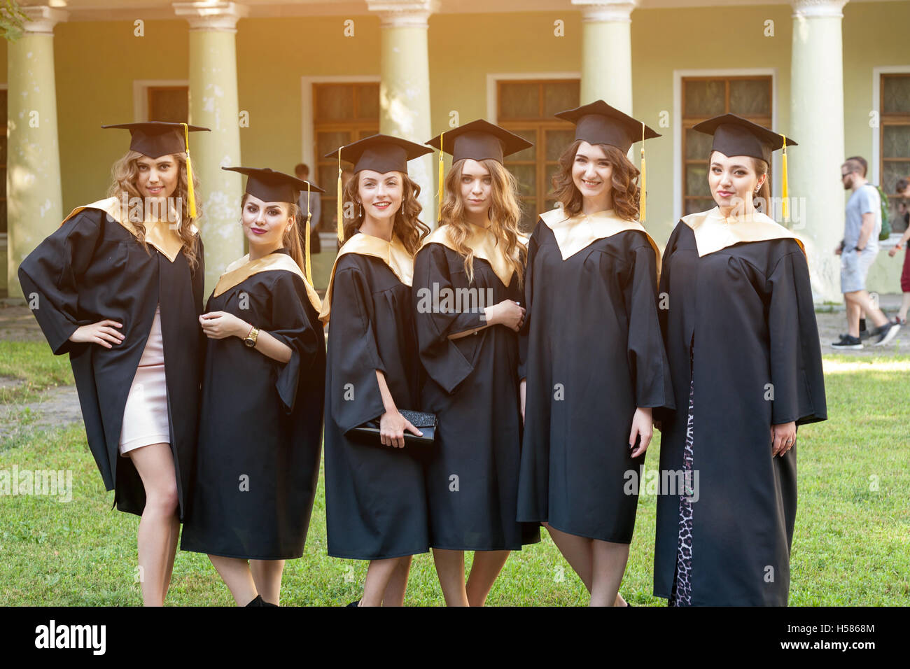 Portrait of happy students in graduation gowns. Happy graduation day ...