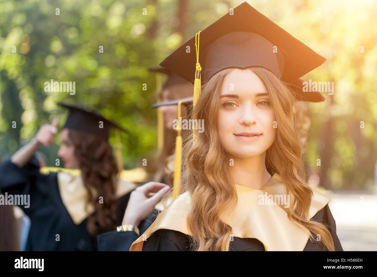 Pretty female college graduate at graduation on university campus Stock ...